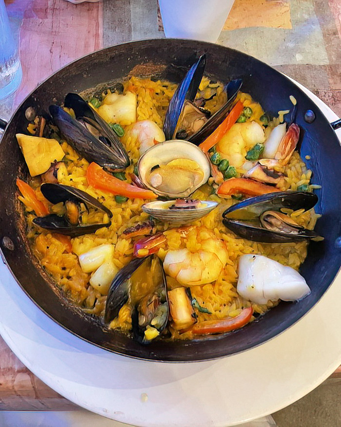 The seafood paella isn't just a dish, it's an event – a colorful celebration where mussels, shrimp, and scallops party with saffron rice.