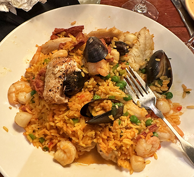 Seafood Paella that's worth the trip alone &ndash; a treasure chest of ocean delights nestled in saffron-kissed rice that whispers "vacation" with every bite.