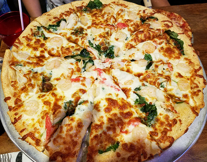 Seafood pizza that would make coastal Italians nod in approval—where cheese stretches for miles and fresh ingredients create a symphony of flavors.