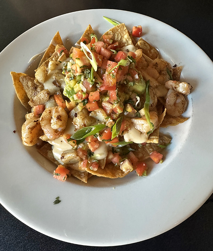 These seafood nachos aren't just appetizers&mdash;they're a fiesta where shrimp and fresh salsa dance across crispy tortilla chips.