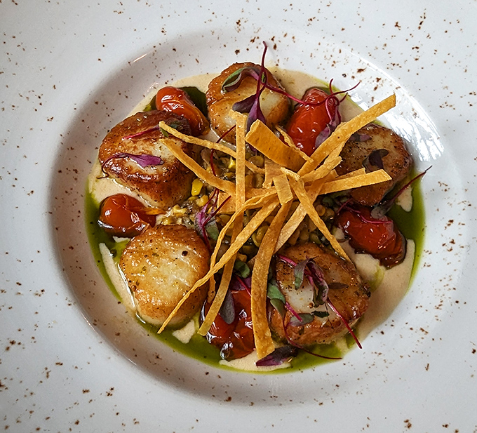 Seared scallops that glisten like precious gems, each bite a masterclass in oceanic perfection.