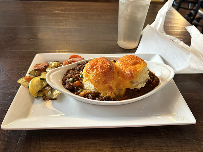 Shepherd's pie done right: savory lamb beneath a golden crown of mashed potatoes. Comfort food that actually comforts rather than just fills.