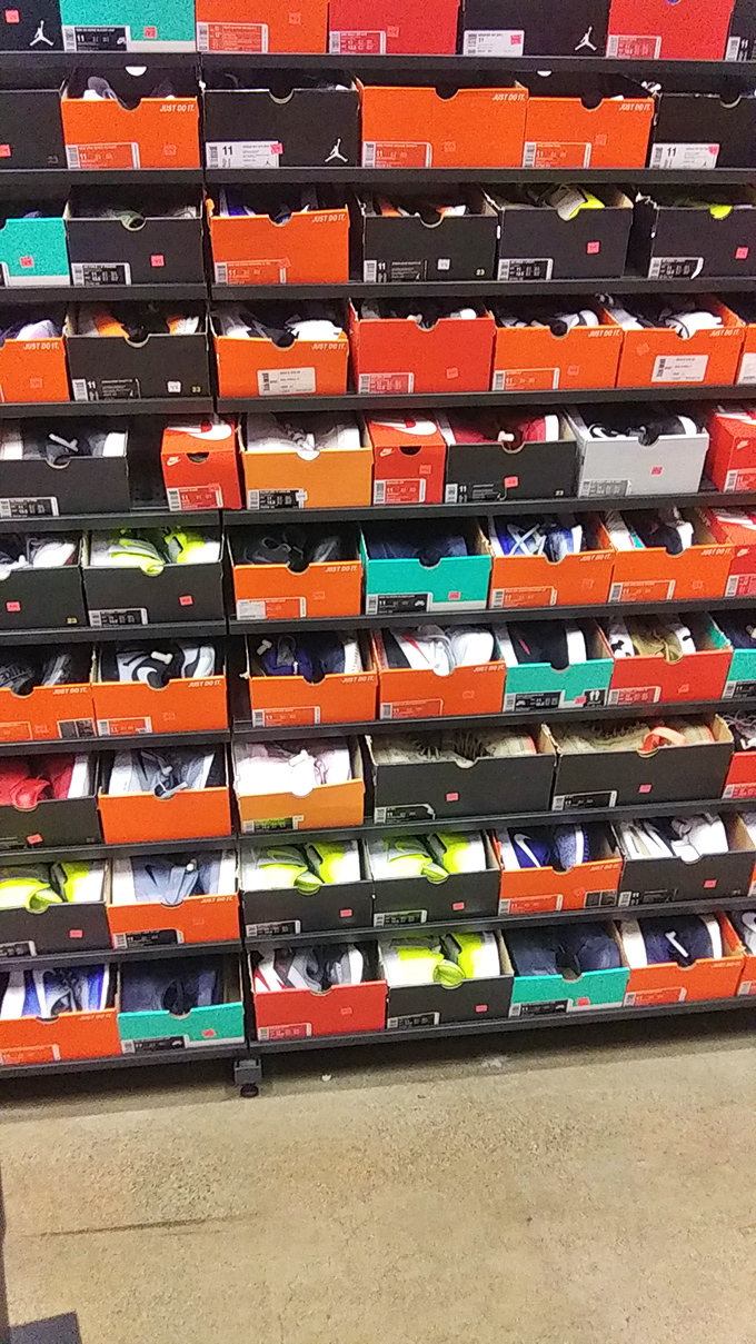 The Nike outlet's sneaker wall resembles a modern art installation, where each colorful box contains not just footwear but the promise of athletic greatness (or at least looking the part).