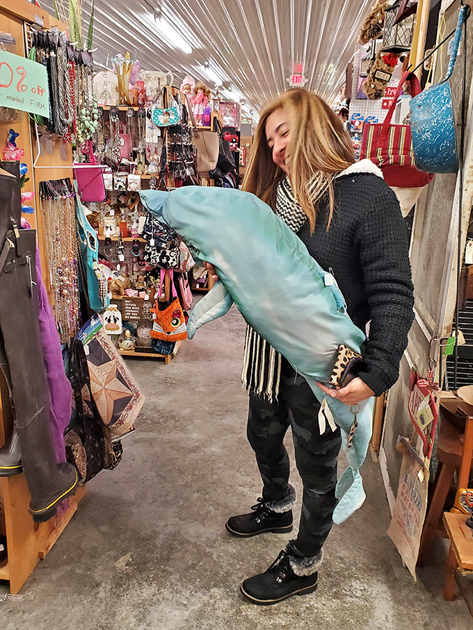 The thrill of the find! A shopper examines her latest treasure, experiencing that universal flea market joy that transcends generations.