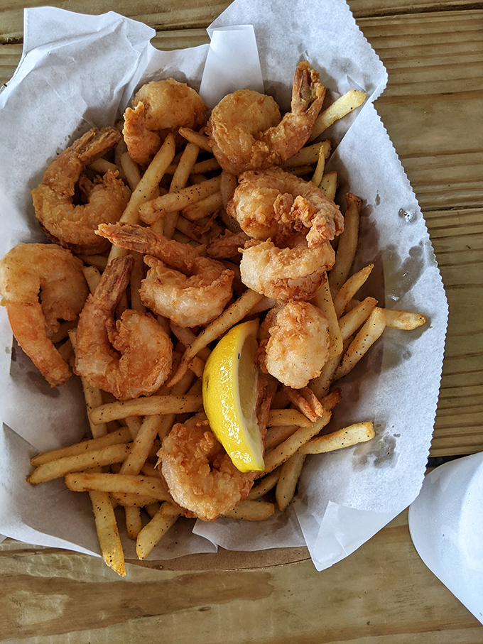 Fried shrimp nestled among french fries &ndash; a basket of golden treasures that would make Neptune himself abandon his trident for a fork.