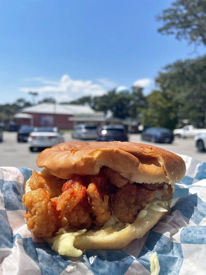 The coastal Carolina classic: a shrimp burger basking in the sunshine. Beach vacation memories between two buns.