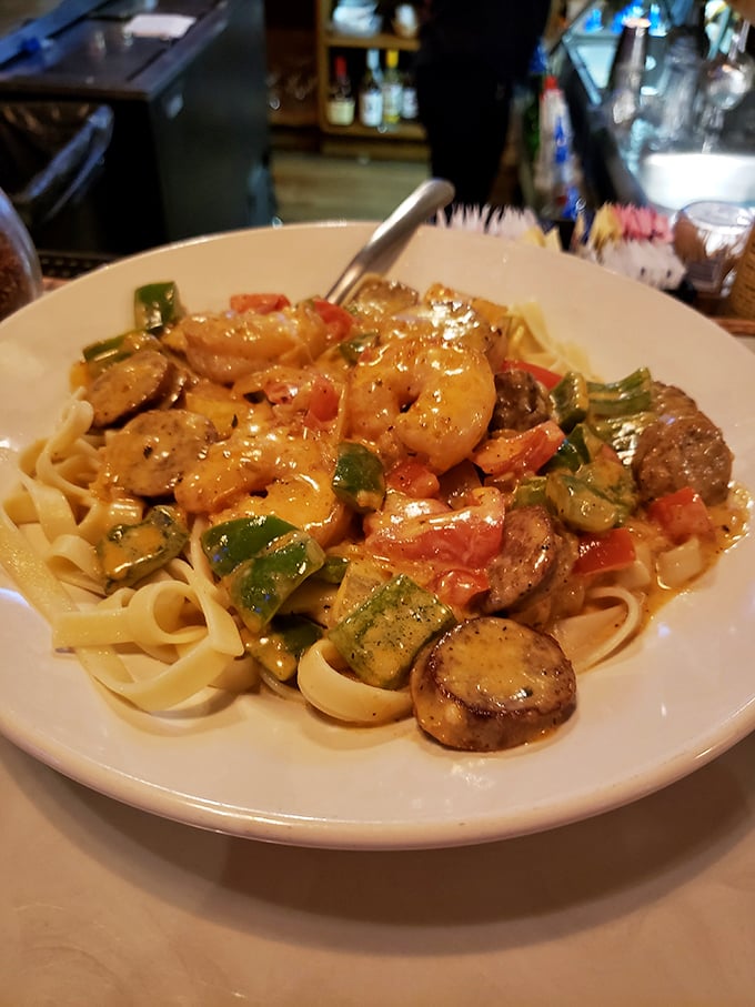 Pasta paradise found! Plump shrimp, colorful vegetables, and perfectly cooked fettuccine swim in a sauce worth sopping up with every last bread crumb.
