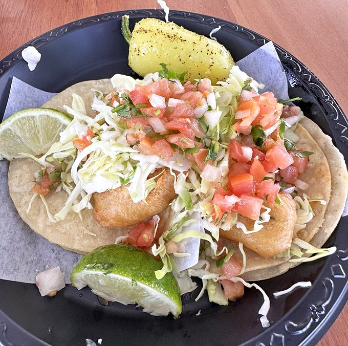 Plump, golden shrimp nestled in a warm tortilla with a mountain of crisp toppings – proof that simplicity, when done right, is culinary poetry.