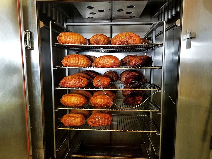 The smoker—where magic happens daily. These burnished beauties have been slow-dancing with applewood smoke until they've reached barbecue nirvana.