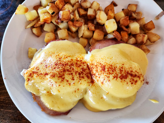 Eggs Benedict reimagined with smoky ham and a dusting of paprika that makes the hollandaise sauce look like a Oregon sunset. Breakfast artistry at its finest.