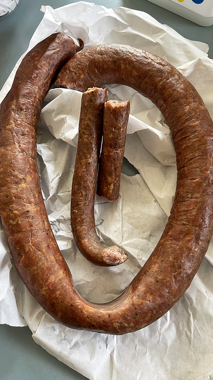 The kielbasa loop&mdash;nature's most perfect circle. Smoke-kissed, glistening, and ready to make your sandwich dreams come true. 