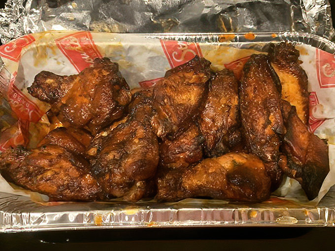 Wings with a bark so perfect they should be in a barbecue museum. These smoky beauties have that coveted mahogany color that whispers, "We took our time with these."