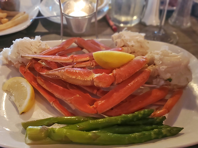 Snow crab legs arranged with military precision, flanked by asparagus soldiers and lemon wedge sentinels. A plate that demands both appetite and strategy.