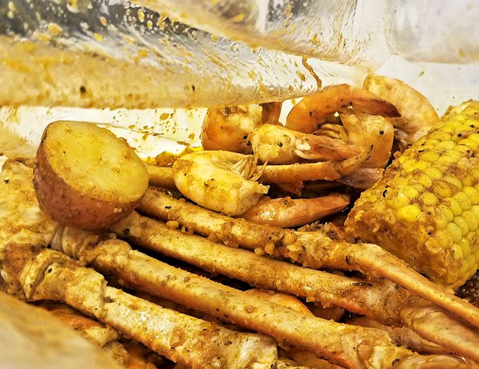 The seafood boil in all its glory&mdash;where shrimp, crab legs, and corn bathe together in seasoned harmony like old friends at a spicy spa.