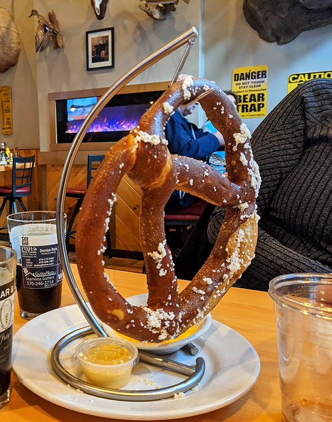 Not your ballpark pretzel! This suspended beauty arrives looking like it's performing an Olympic gymnastics routine, with mustard that deserves its own gold medal.