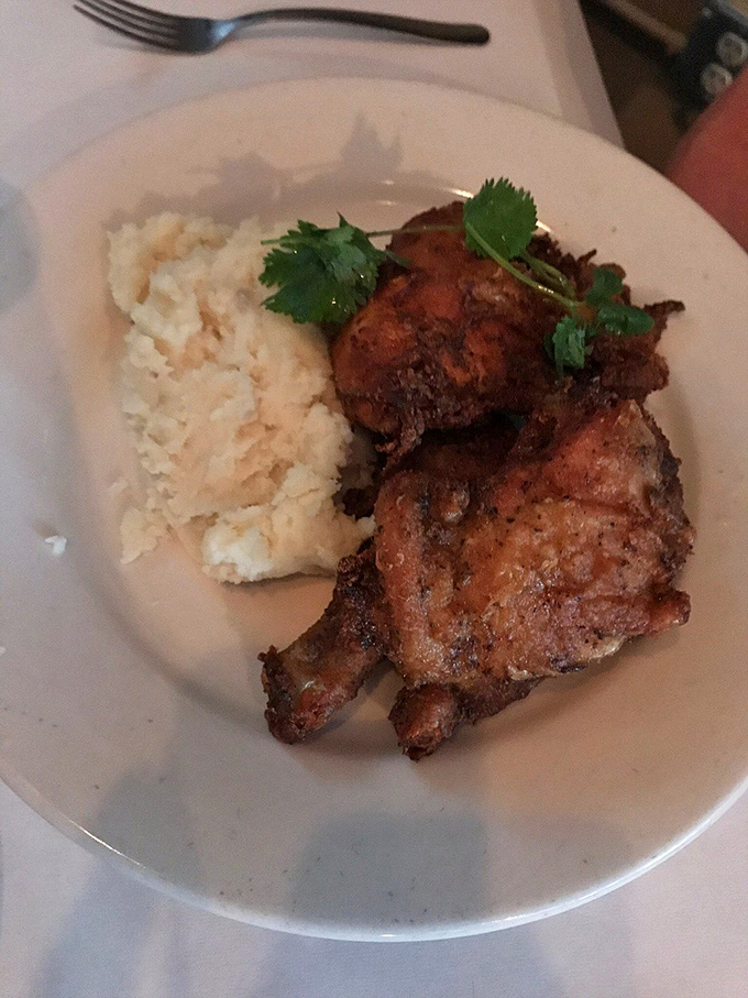 Southern fried chicken and mashed potatoes &ndash; comfort food elevated to art form. That crispy exterior shatters with promise while hiding juicy perfection beneath.