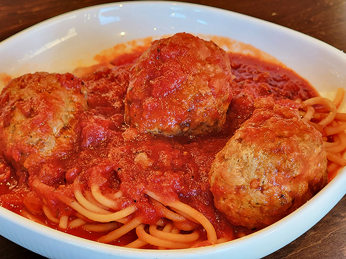 These meatballs aren't just sitting on the pasta&mdash;they're holding court. Three tender spheres of seasoned perfection that would make any nonna nod in approval.
