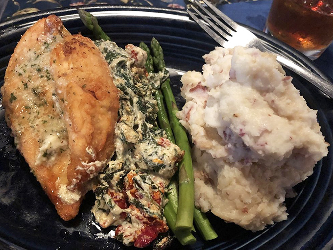 This isn't just chicken&mdash;it's a masterclass in comfort. Spinach-stuffed breast alongside creamy mashed potatoes and asparagus spears standing at attention.