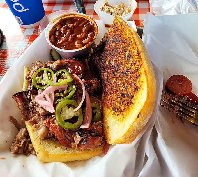 The Squealin' Pig sandwich: architectural marvel meets flavor explosion, requiring both hands and complete dedication.