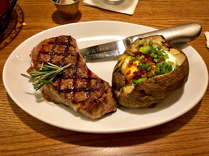 The grill marks on that steak tell a story of fire-kissed perfection, while the loaded baked potato stands by as the ultimate wingman.