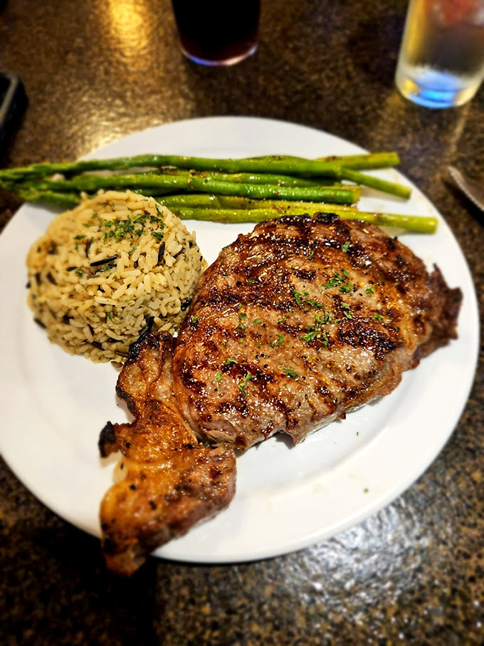 A perfectly grilled steak with just the right char marks, tender asparagus, and seasoned rice&mdash;the holy trinity of supper club perfection.