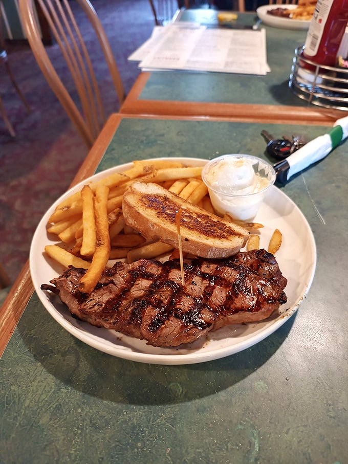 A perfectly grilled steak with golden fries and Texas toast&mdash;proof that sometimes the simplest pleasures are the most profound.