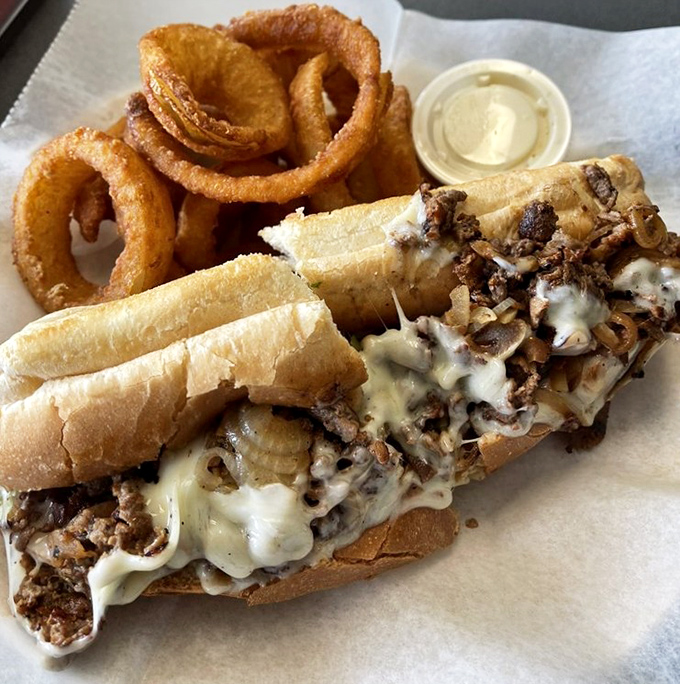 The Philly cheesesteak that launched a thousand cravings, with melted cheese cascading over thinly sliced steak like a dairy waterfall.
