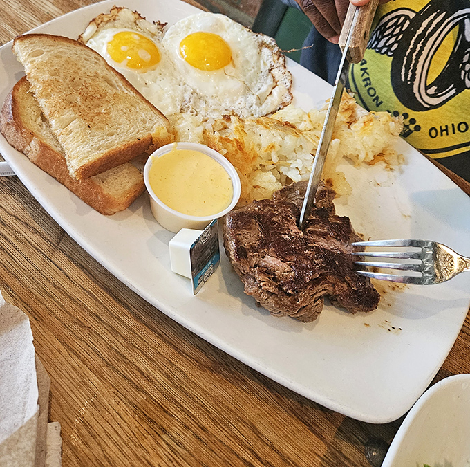 The star of the show: a perfectly seared steak alongside sunny-side-up eggs that practically high-five your taste buds with every bite.