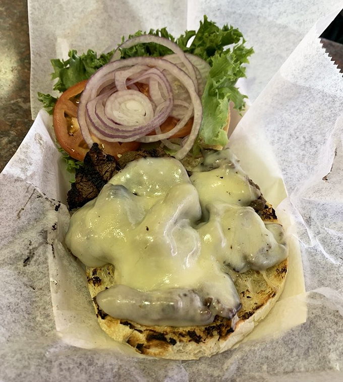 The steak sandwich doesn't just sit there &ndash; it beckons with melted cheese cascading like a dairy waterfall over perfectly grilled beef. Resistance is futile.