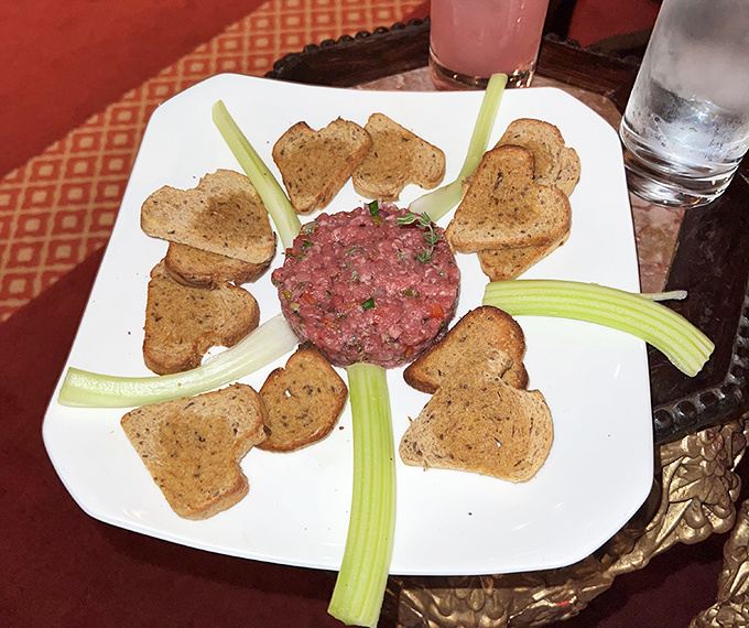 Steak tartare arranged like a sunburst&mdash;raw beef never looked so civilized, surrounded by its entourage of toast points and celery spears.