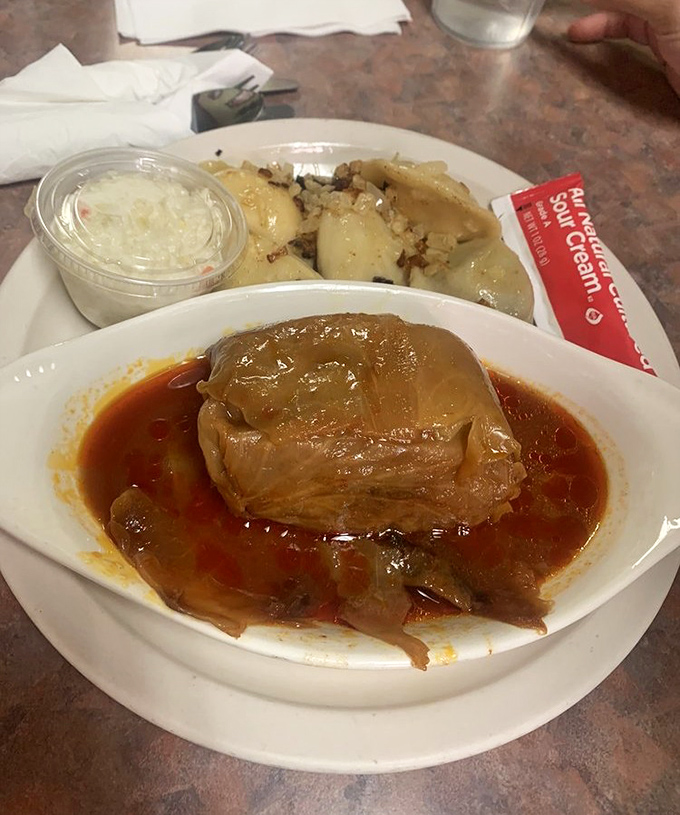 The stuffed cabbage roll sits in its tomato bath like royalty. One bite of this golabki and you'll understand why Polish grandmothers are culinary geniuses.
