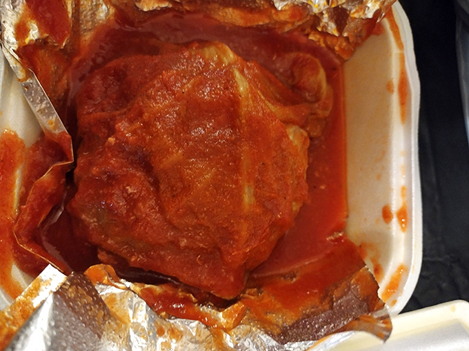 Behold the stuffed cabbage roll—a tidy package of seasoned goodness bathing in tomato sauce that would make any Polish grandmother nod in approval.