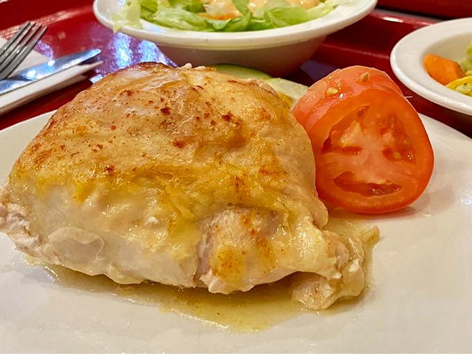 Stuffed chicken breast that your grandmother would approve of&mdash;golden, juicy, and served without pretension. The tomato garnish is just showing off.