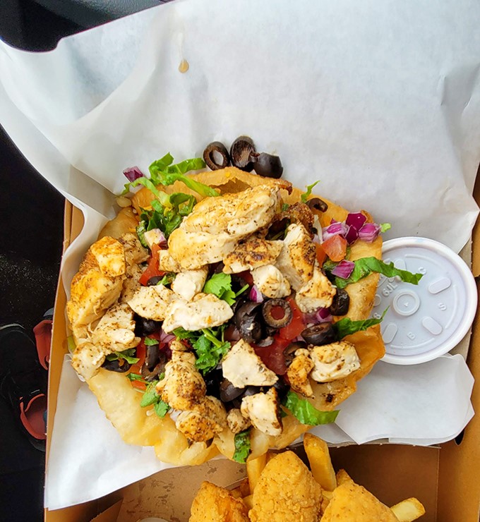 Who needs a fancy salad when you can have grilled chicken, fresh veggies, and olives atop a bed of golden fries? Comfort food gets an upgrade.