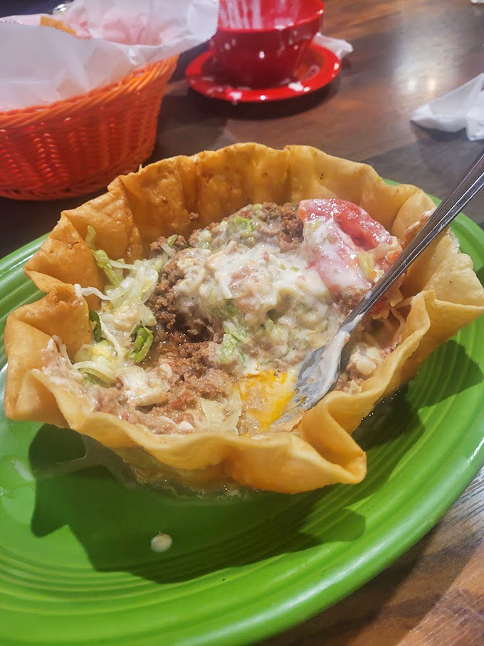 The taco salad arrives like edible architecture&mdash;crispy shell cradling seasoned meat and toppings that somehow makes salad feel like an indulgence.