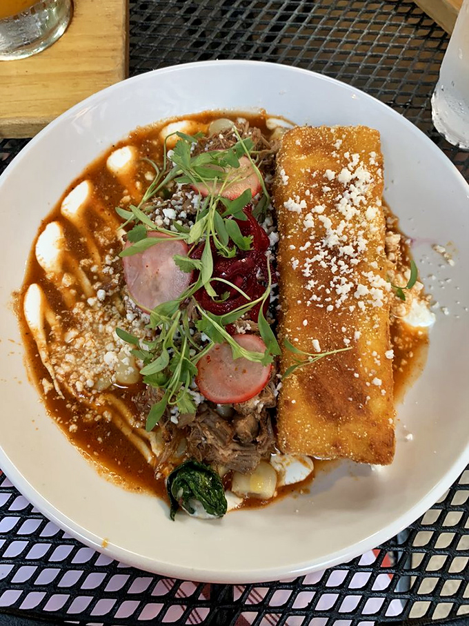 Tamale meets fine dining in this artfully plated creation. The crispy exterior gives way to tender filling, all swimming in a mole that demands bread-sopping.
