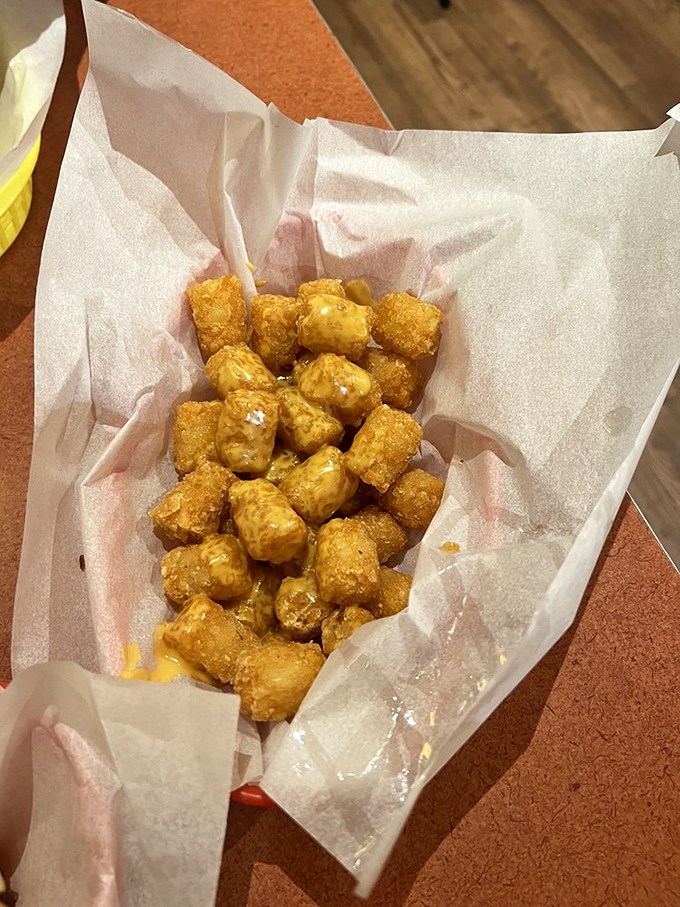 These aren't your average tater tots; they're crispy on the outside, fluffy on the inside, and drizzled with cheese—the holy trinity of potato perfection.