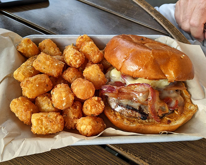 This burger's sidekick deserves its own spotlight &ndash; golden tater tots that crunch like your favorite vinyl record before melting into potato perfection.