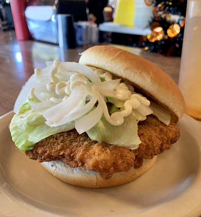 The breaded tenderloin&mdash;Indiana's unofficial state sandwich&mdash;extends gloriously beyond its bun boundaries, a crispy-golden testament to Hoosier hospitality on a plate.