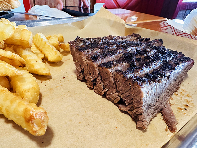 Texas brisket with that telltale smoke ring&mdash;barbecue's equivalent of Olympic gold. The crinkle-cut fries are just there for moral support.