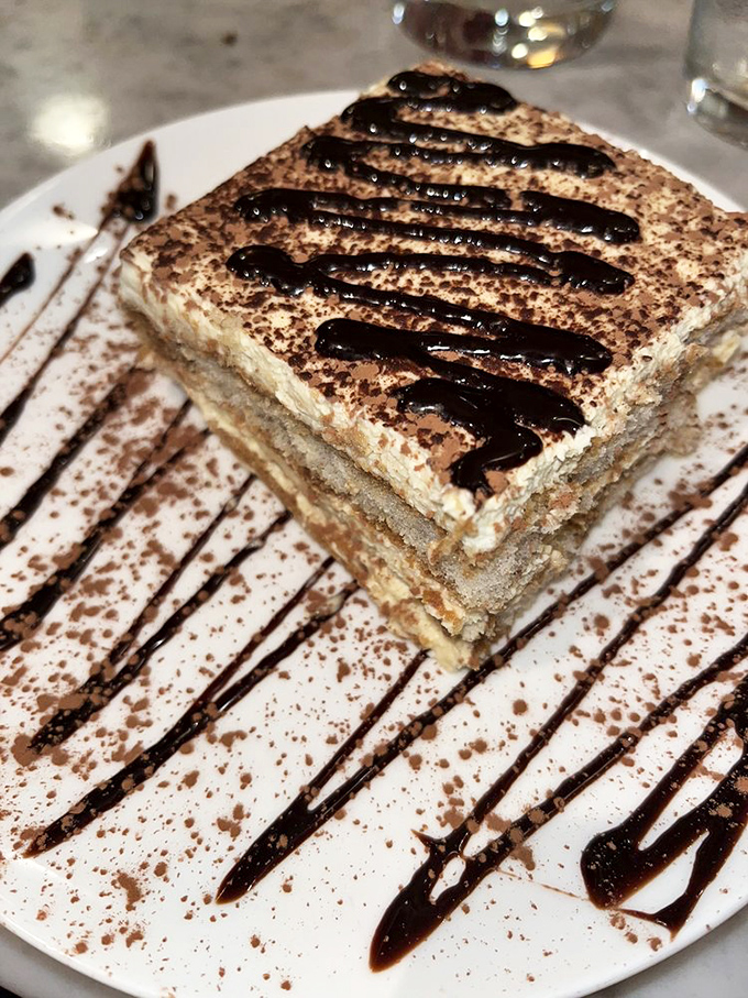 Tiramisu that would make your Italian grandmother weep with joy. Those chocolate drizzles aren't just decoration &ndash; they're pathways to happiness.