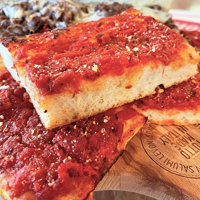 Tomato pie that makes you question everything you thought you knew about pizza. The simplicity is the genius&mdash;just perfect crust, vibrant sauce, and a dusting of cheese.