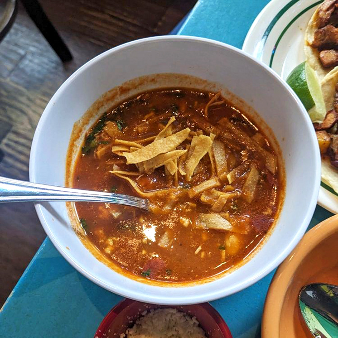 Tortilla soup that looks like autumn in a bowl, with those crispy tortilla strips standing at attention.
