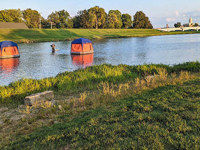Treasure Island Park offers a peaceful water feature where these tent-like structures create a whimsical scene against the backdrop of Troy's skyline.