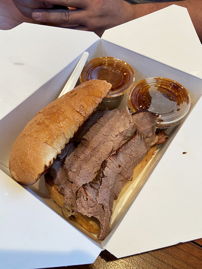 Tri-tip sandwich perfection: thinly sliced, perfectly smoked beef on garlic toast with two sauce options. The kind of sandwich that ruins all future sandwiches.