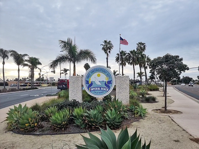 Triangle Park greets visitors with palms and a welcoming sign, reminding everyone they&rsquo;ve arrived in laid-back Imperial Beach, California.
