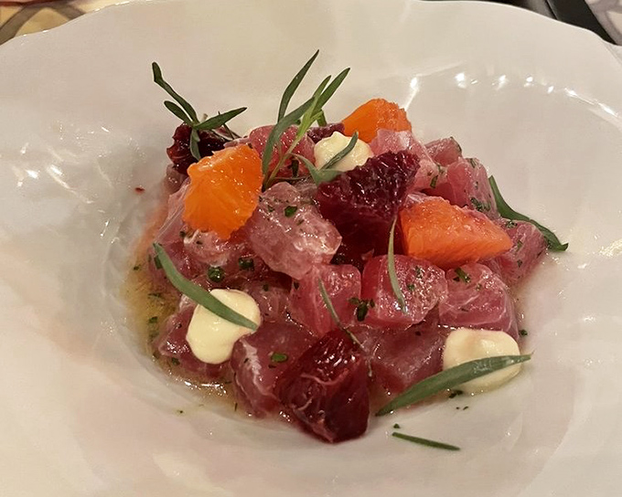 This veal tartare isn't just a dish—it's edible artwork. Vibrant citrus and microgreens transform raw protein into a symphony of textures and flavors.