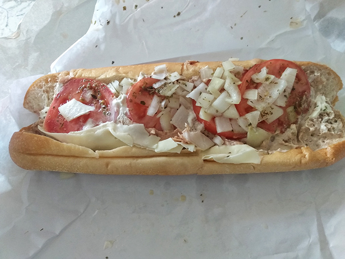 Behold the art of proper sandwich construction—layers of tuna, crisp vegetables, and just the right amount of seasoning on bread that knows its purpose.