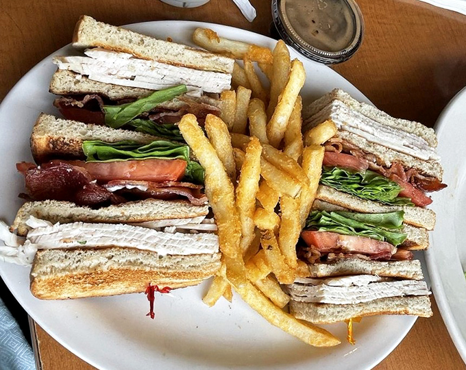 The turkey club sandwich that proves sometimes perfection comes stacked three stories high with fries.