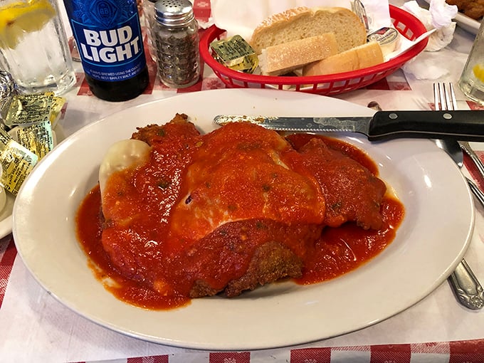 The legendary veal parmigiana that launched a thousand road trips, swimming in that vibrant tomato sauce that tastes like someone's nonna has been stirring it all day.
